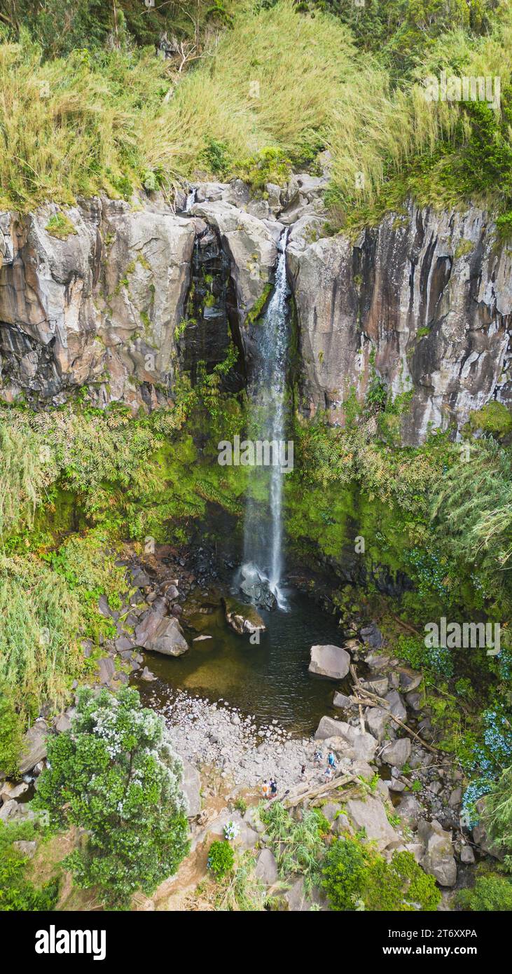 A bird's eye view of a majestic waterfall cascading over rocky terrain ...