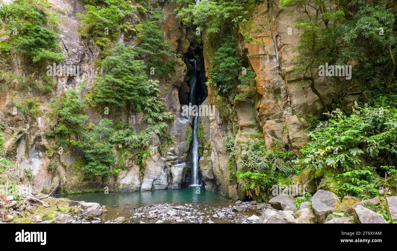 A Majestic Waterfall Cascades Down A Rocky Cliff Side Creating A