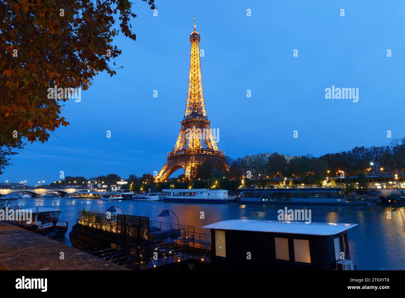 The night view of the Eiffel Tower, famous monument glowing at dusk ...