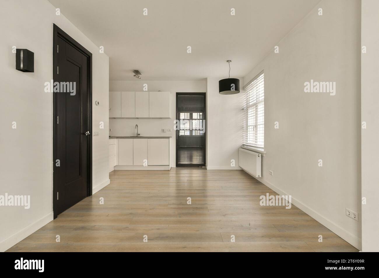 an empty room with white walls and wood flooring on the right side ...