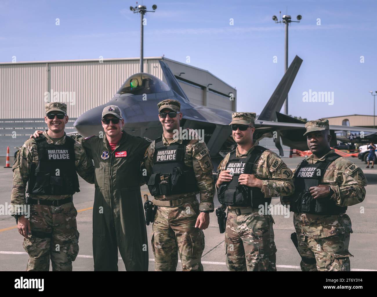 The military police officers stand with United States Air Force pilot ...