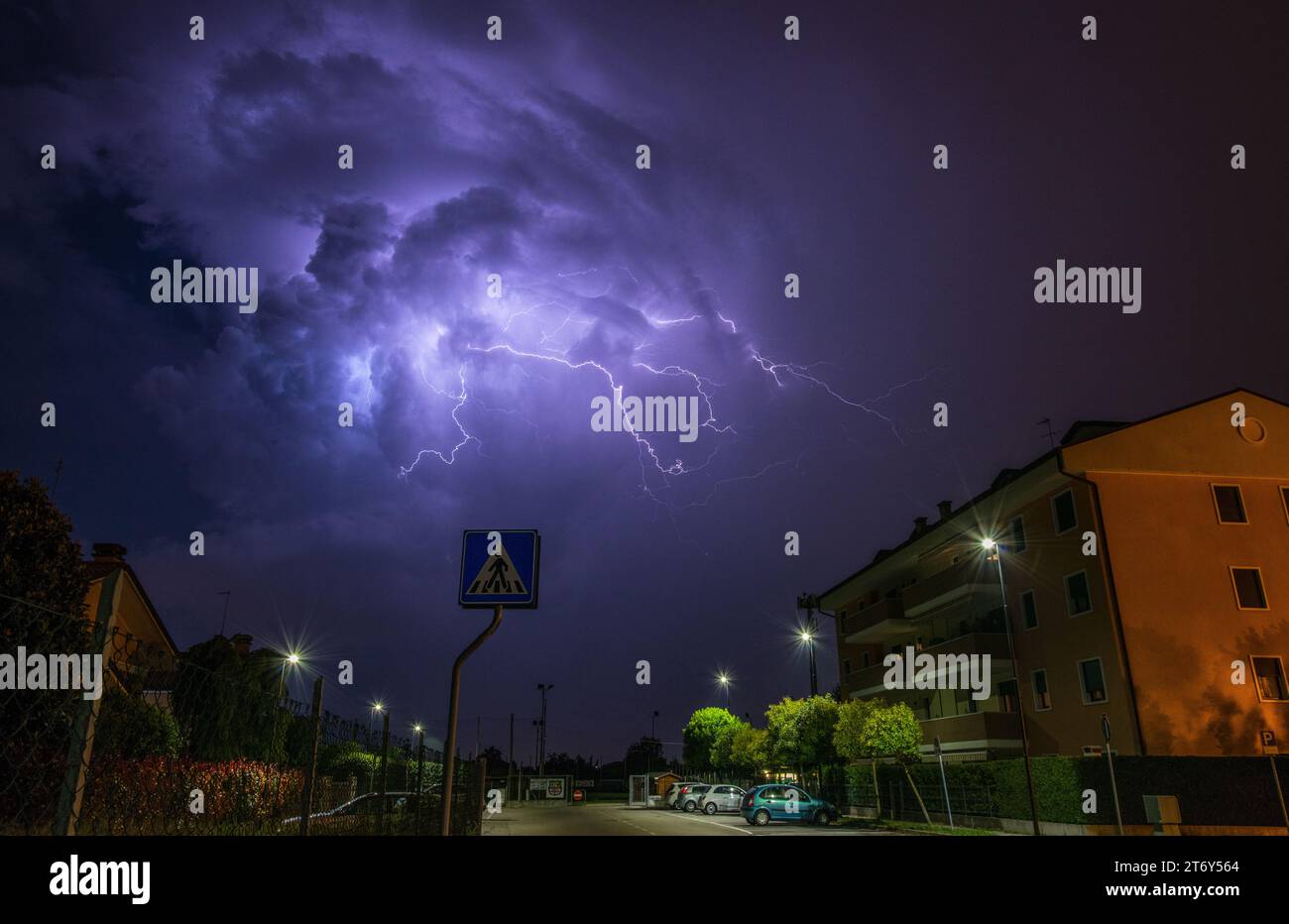 Multiple lightning branches out of massive thunderhead towering above ...