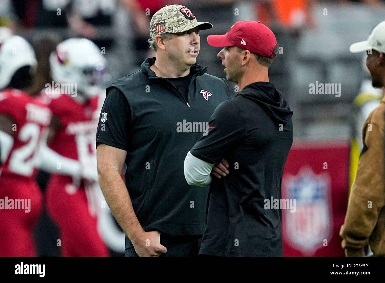 Atlanta Falcons head coach Arthur Smith speaks with Arizona Cardinals head coach Jonathan Gannon ...
