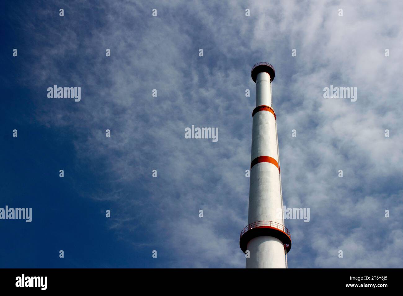 Garbage incinerator chimney painted white and red Stock Photo - Alamy