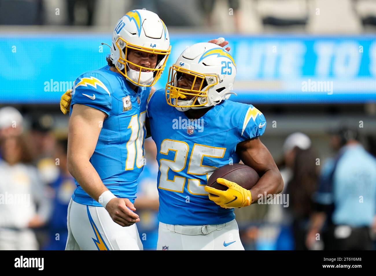 Los Angeles Chargers quarterback Justin Herbert (10) hugs running back ...