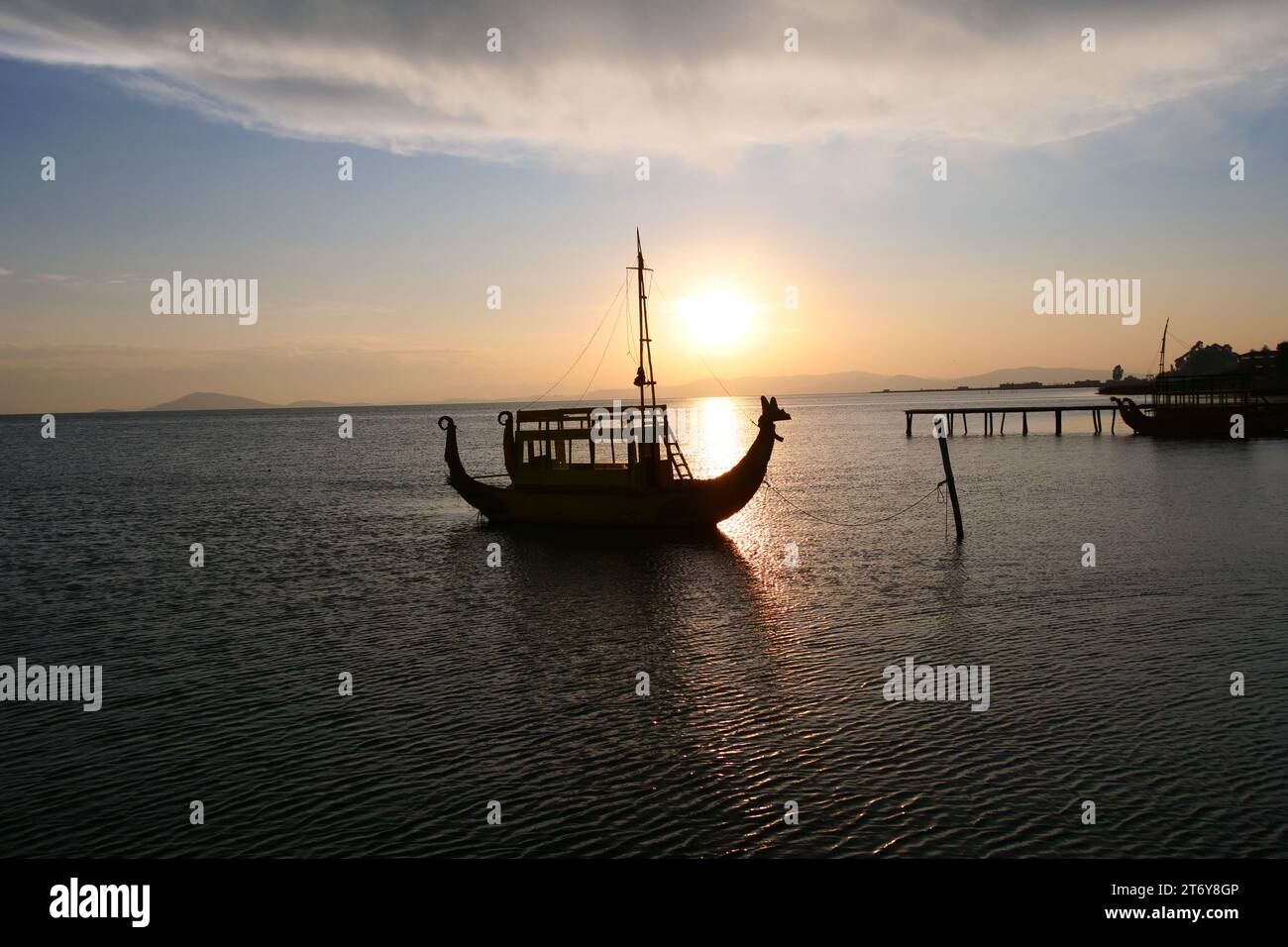Traditional reed boat on lake Titicaca, Bolivia, with sun setting on ...