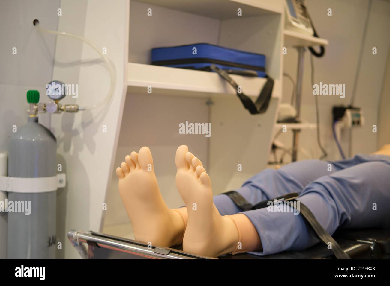 Patient lying on a stretcher in a training dummy in an ambulance. Medical equipment Stock Photo ...