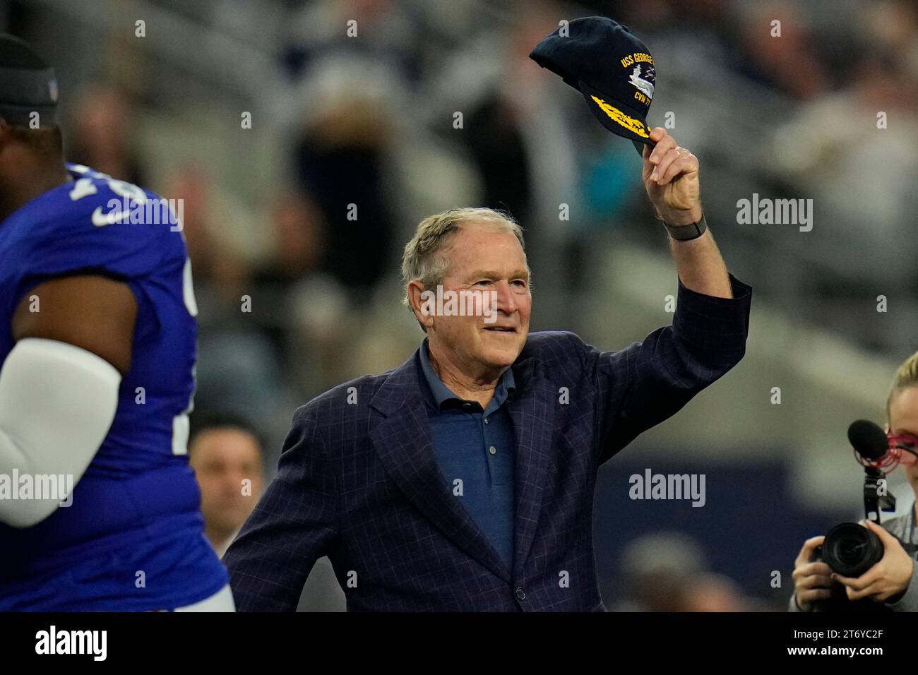 Former President George W. Bush tips his hat to the crowd before an NFL ...