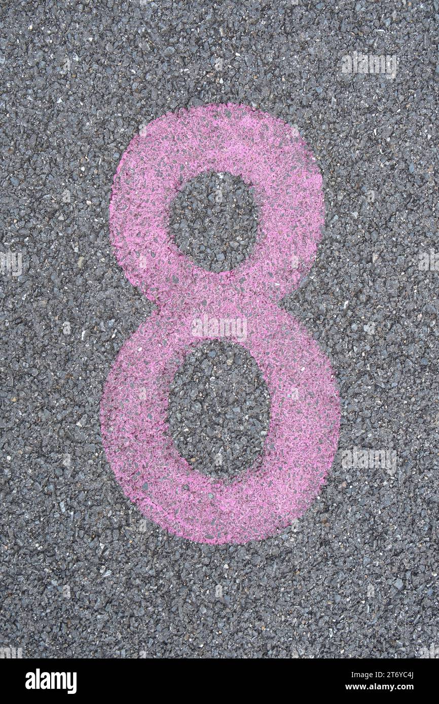 the number 8 eight are drawn with color paint on asphalt. a children's ...