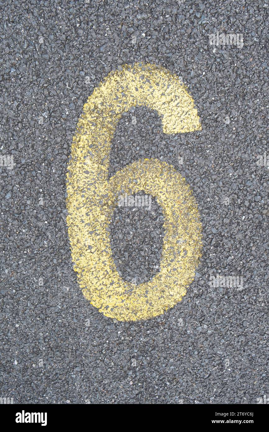 the number 6 six are drawn with color paint on asphalt. a children's ...