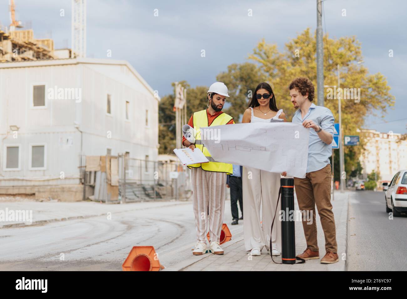 Architects And Engineers Analyze Blueprints Discuss Project Planning And Costs And Collaborate