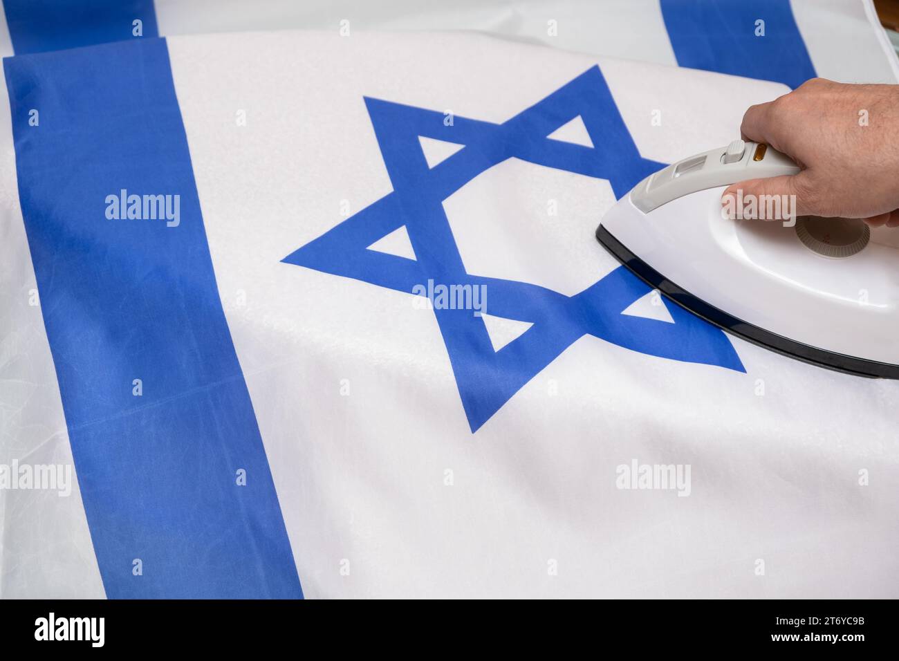 Patriot ironing Israeli national flag, state Israel on Independence day ...