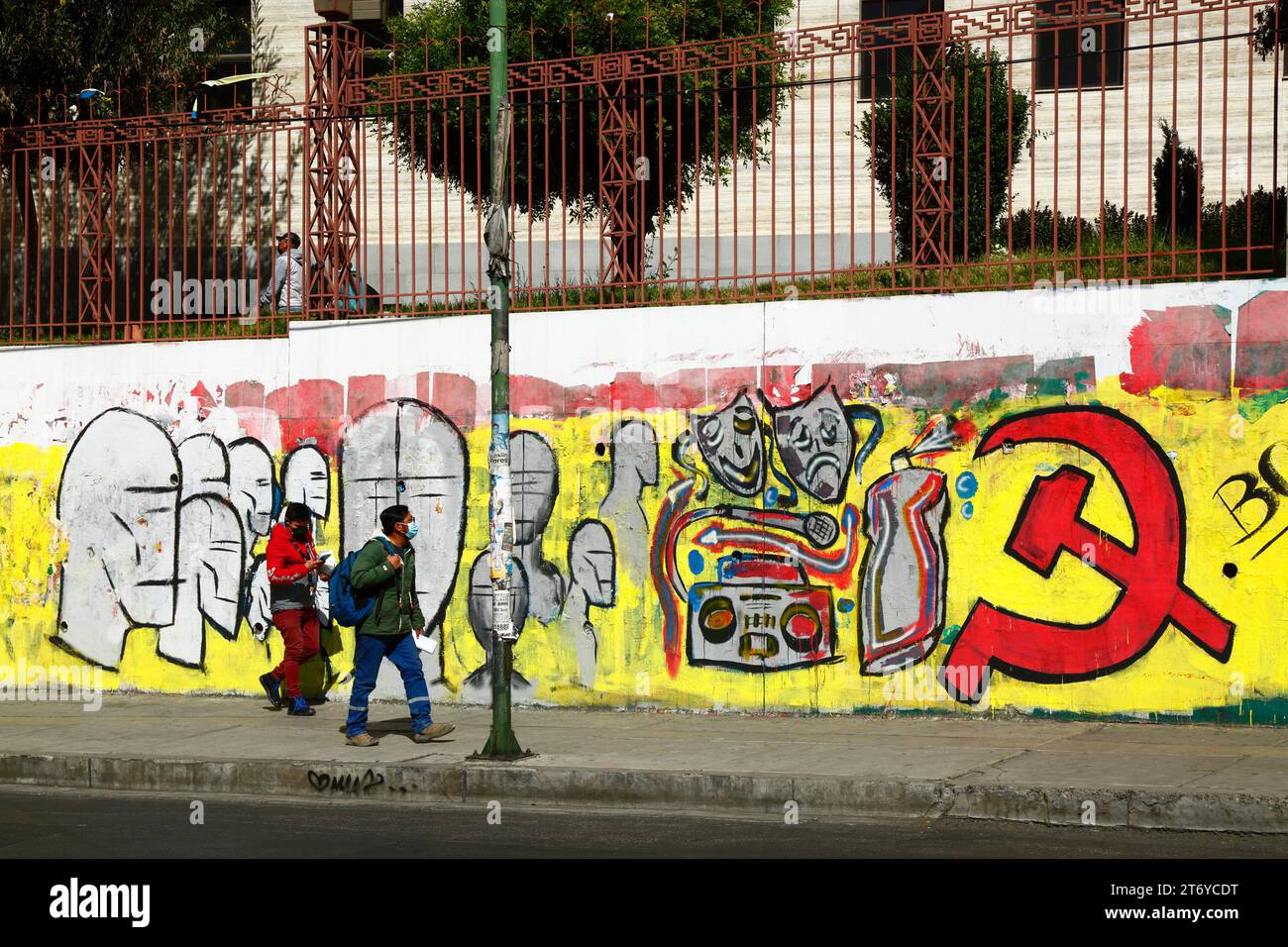 Men walk past a mural by the Bolivian Communist Party near the main ...