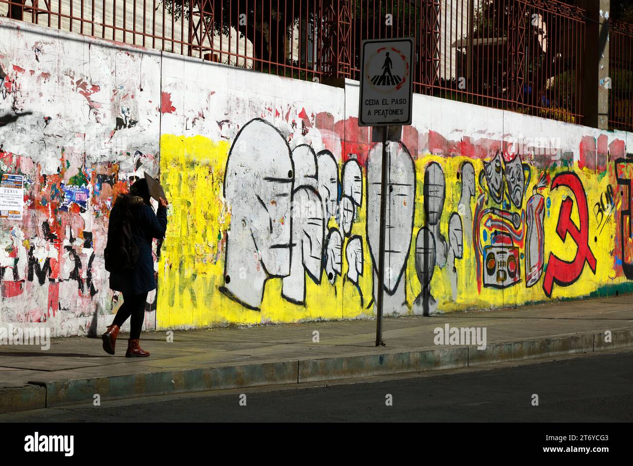 A woman walks past a mural by the Bolivian Communist Party near the ...