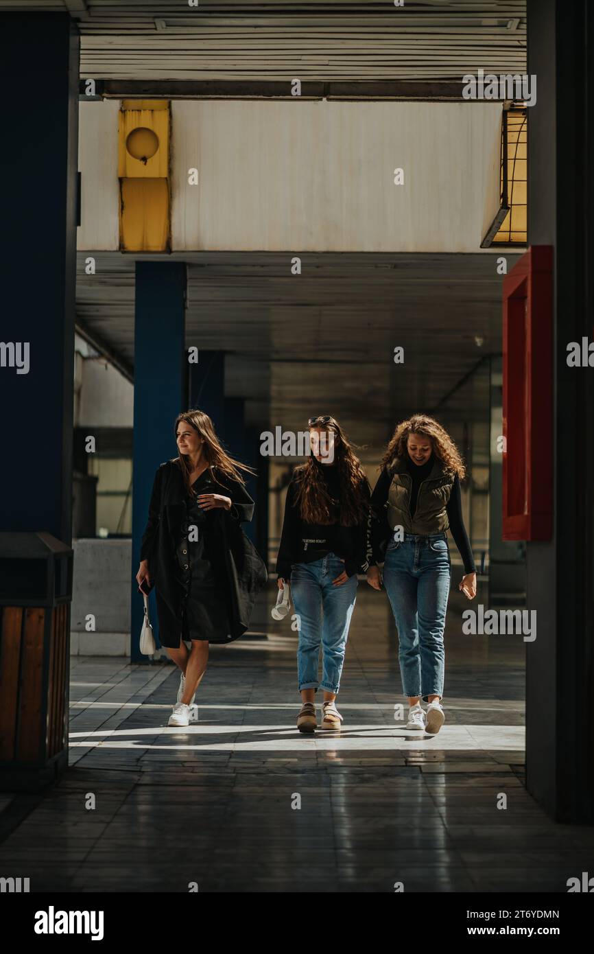 Three girls walking at the shopping mall Stock Photo - Alamy