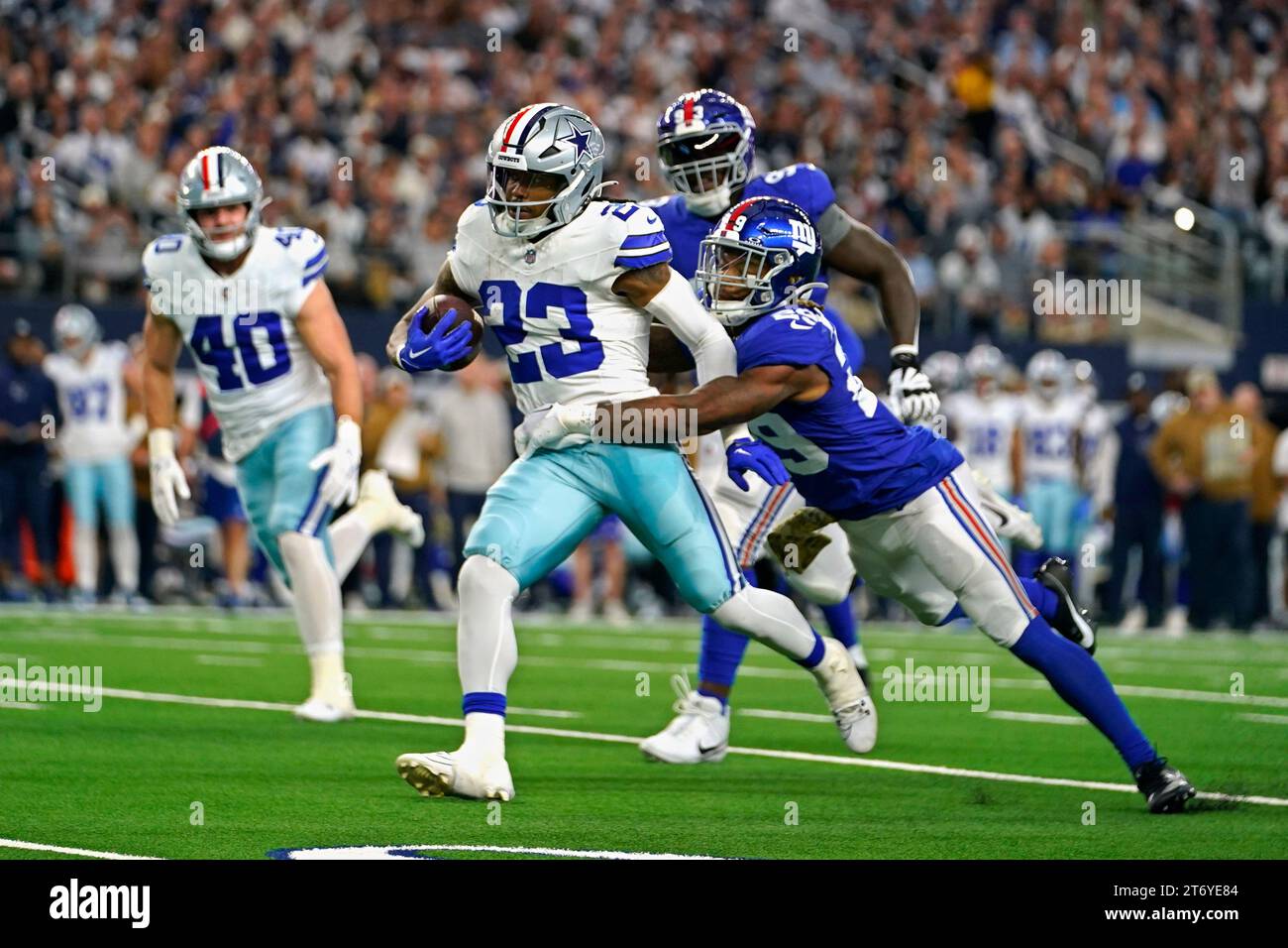 New York Giants safety Xavier McKinney, right, attempts to tackle Dallas Cowboys running back ...