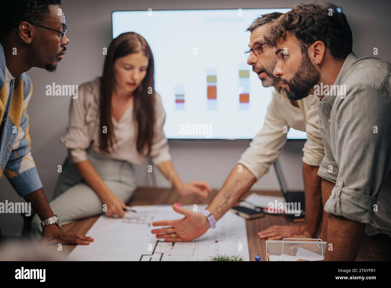 Diverse professionals collaborate in a modern office meeting. They ...