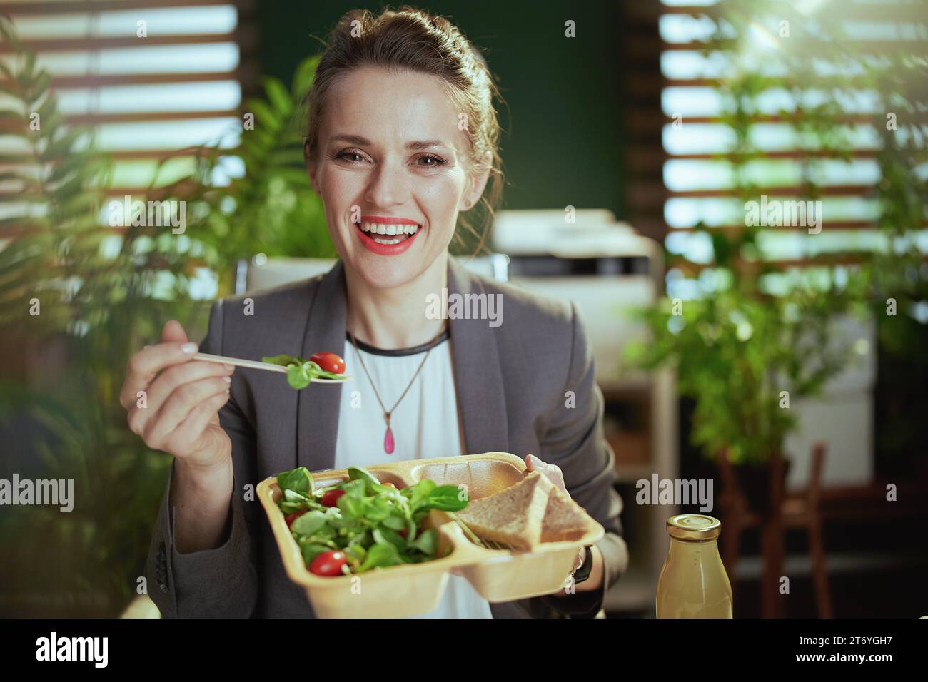 Sustainable workplace. happy modern small business owner woman in a ...