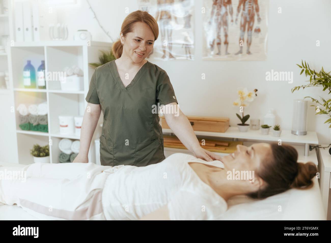 Healthcare Time Smiling Massage Therapist Woman In Massage Cabinet