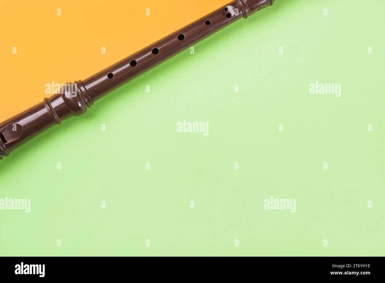 Close up block flute dual orange green background Stock Photo - Alamy
