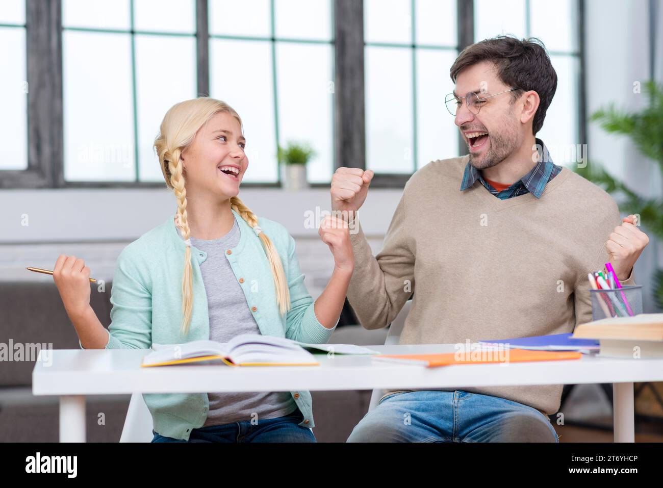 Teacher young student being successful Stock Photo - Alamy