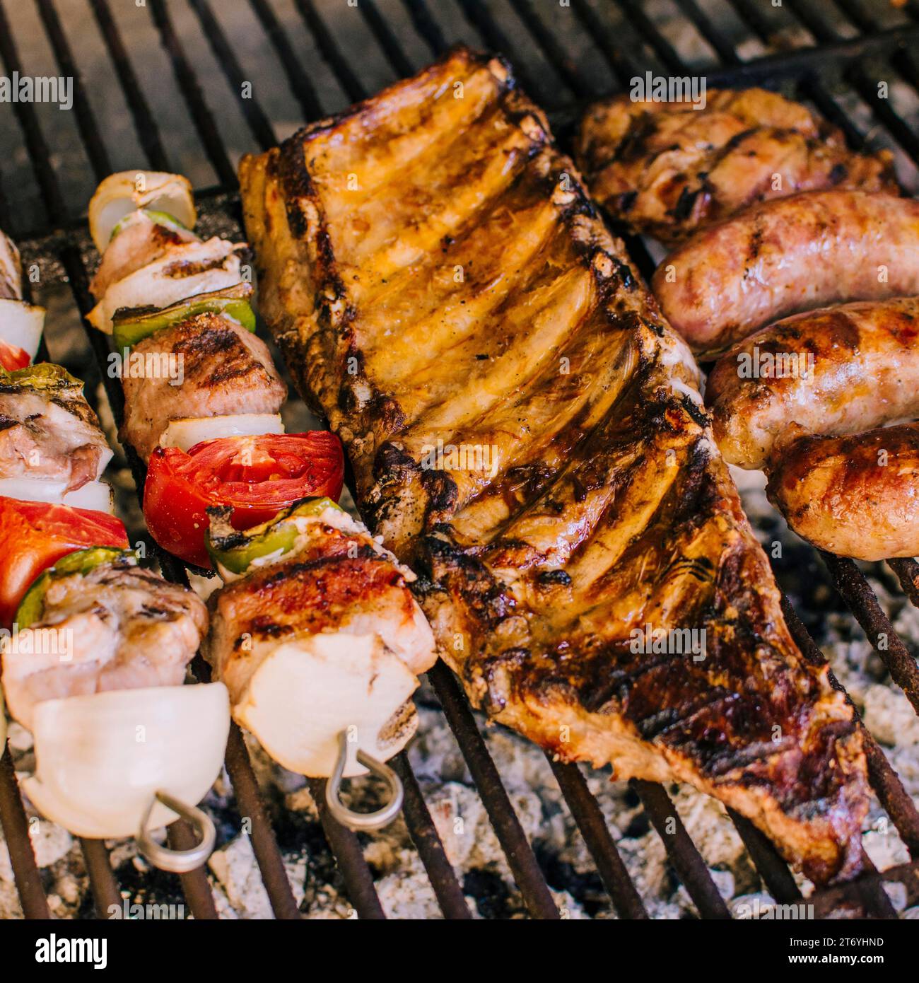 Well grilled meat pieces vegetables grill charcoal Stock Photo - Alamy