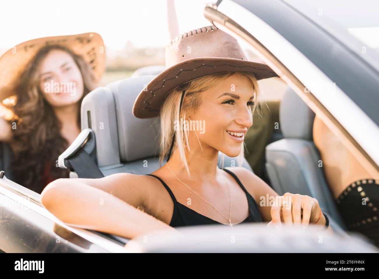 Woman cowboy hat sitting car Stock Photo - Alamy