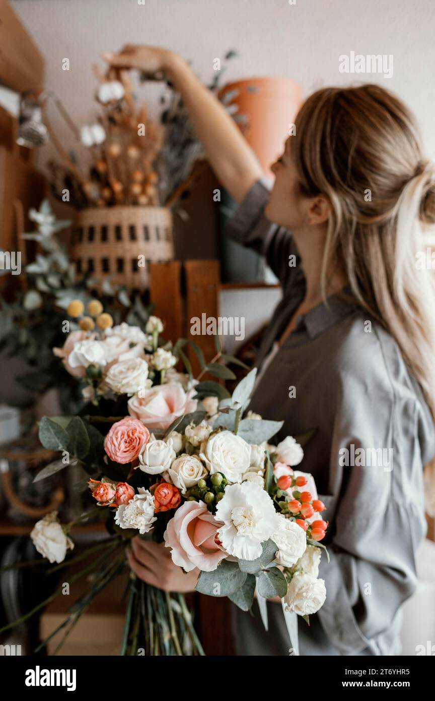 Woman making beautiful floral arrangement Stock Photo - Alamy