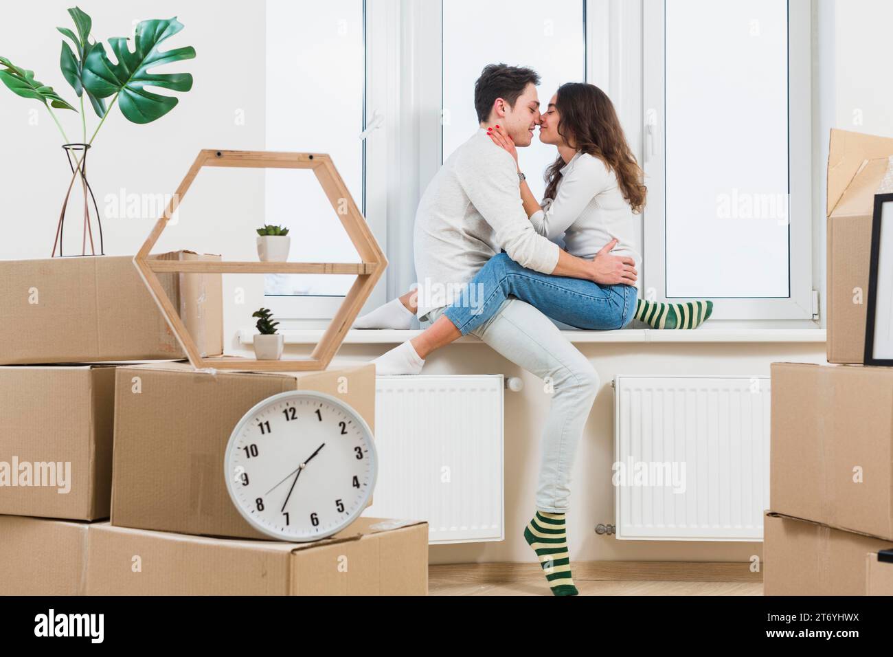 Young couple kissing each other their new home Stock Photo - Alamy