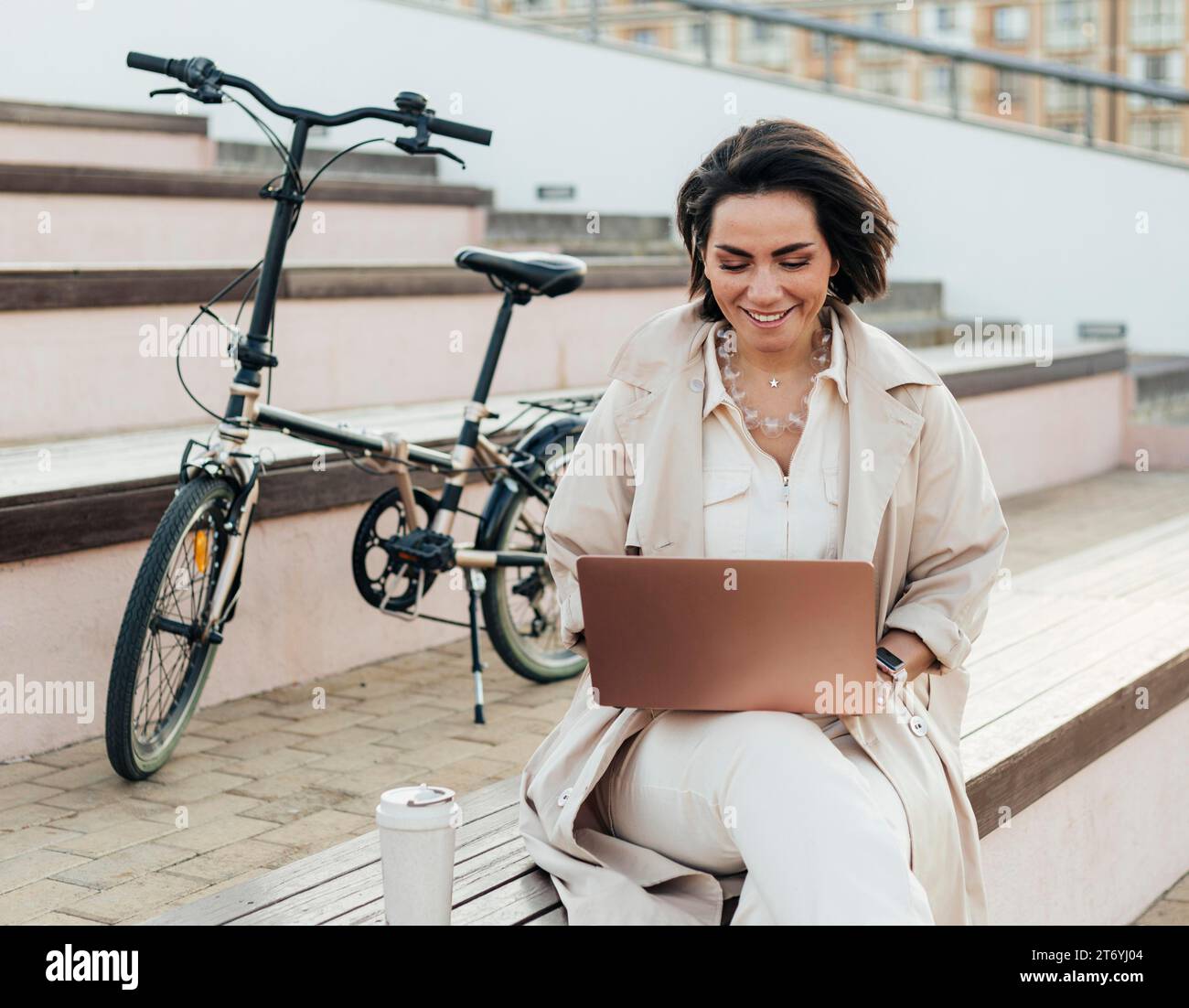 Adult woman browsing laptop outdoors Stock Photo - Alamy