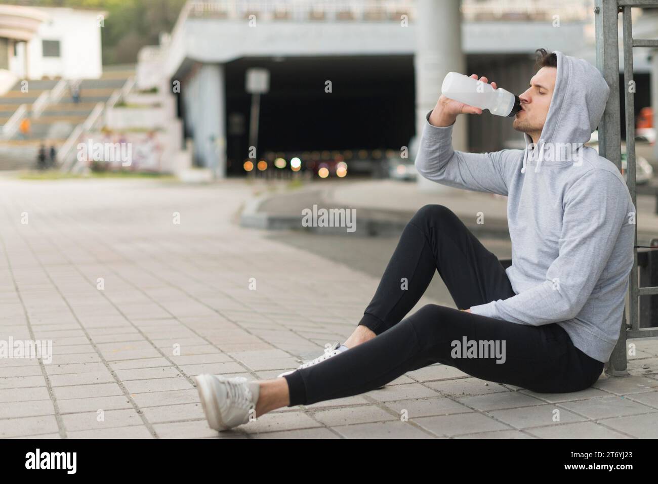 Adult male drinking water outdoors Stock Photo - Alamy