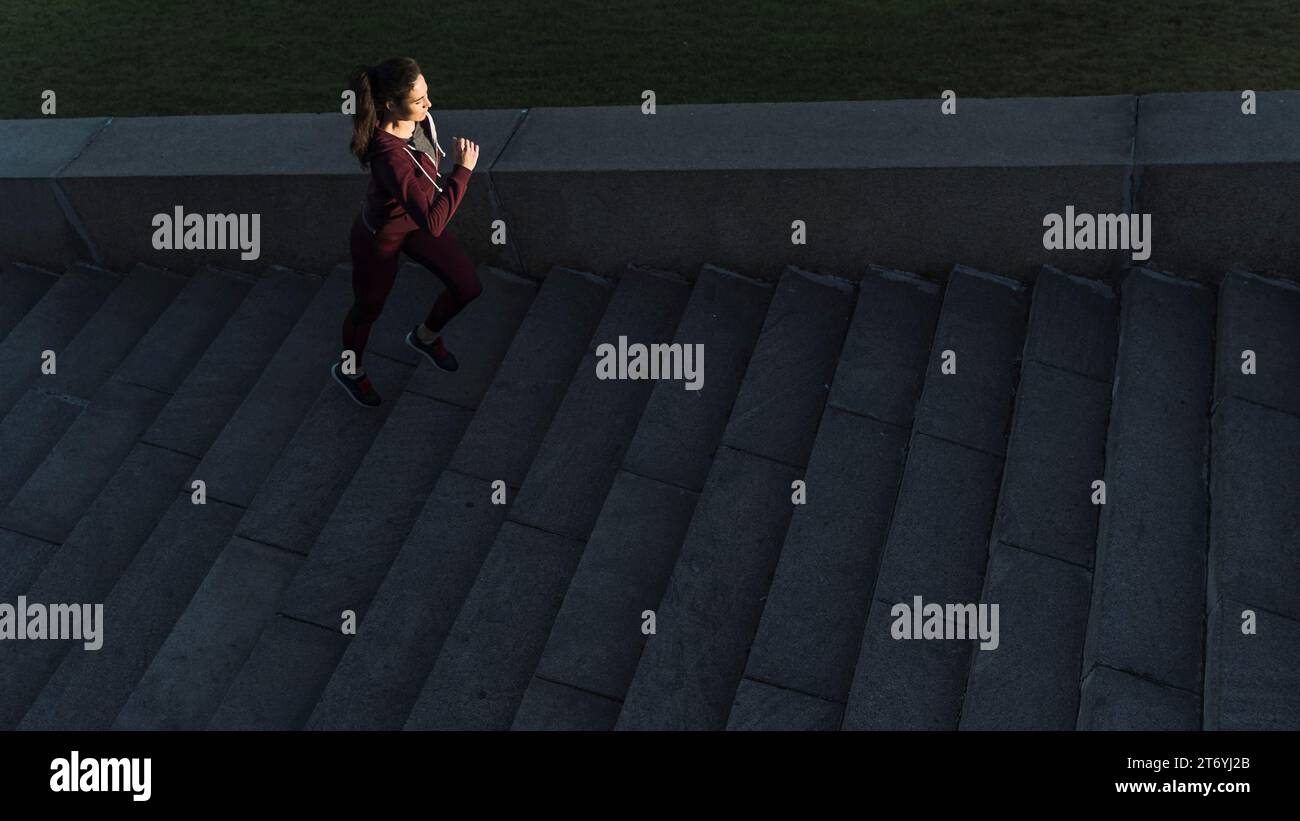 Active young woman climbing stairs Stock Photo - Alamy
