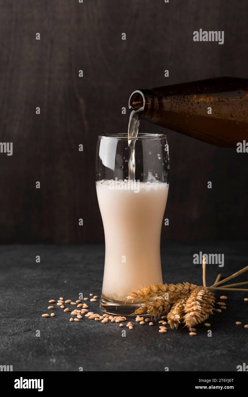 Beer bottle pouring beer glass Stock Photo - Alamy
