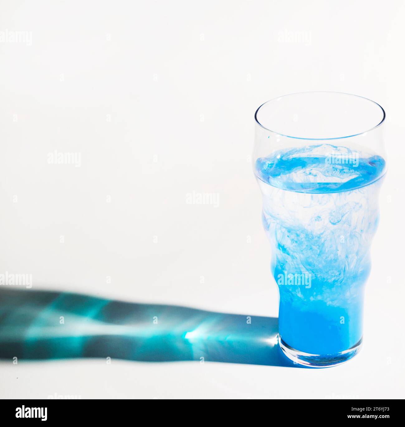 Blue glass water with bright shadow white background Stock Photo - Alamy