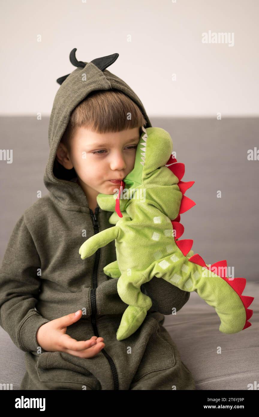 Boy dinosaur costume playing Stock Photo - Alamy