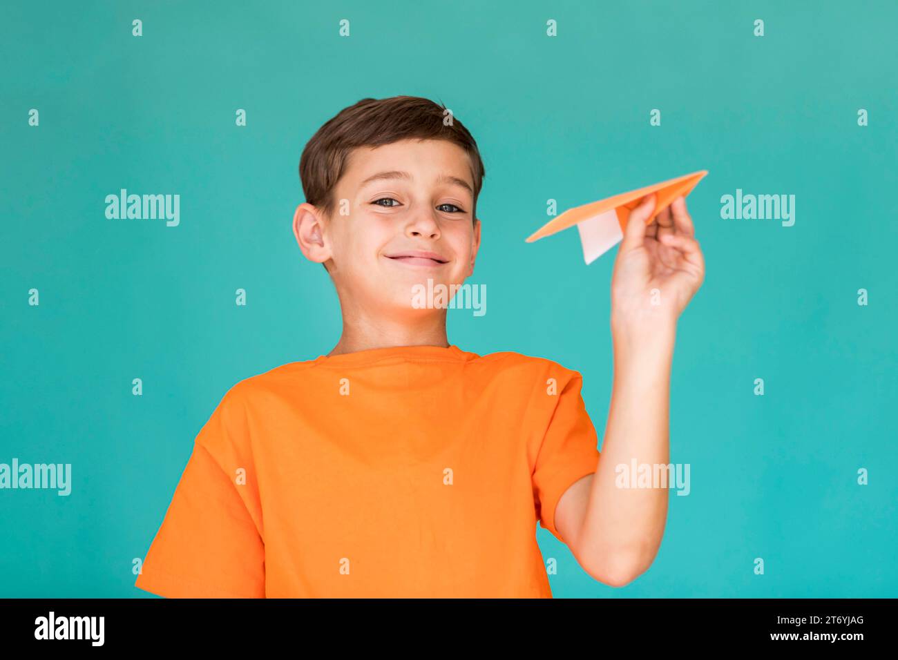Boy getting ready throw paper airplane Stock Photo - Alamy