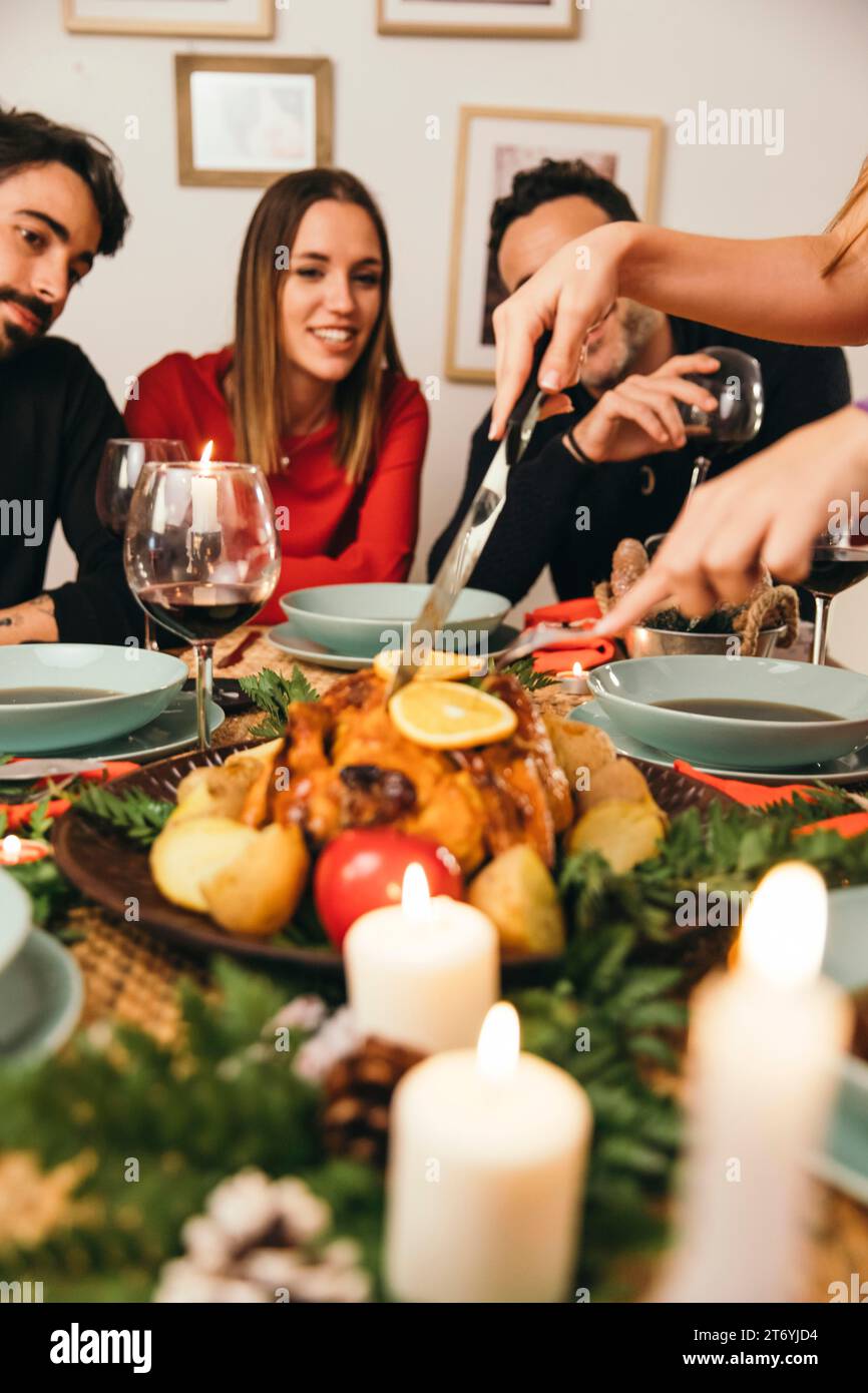 Christmas dinner with friends looking turkey Stock Photo - Alamy