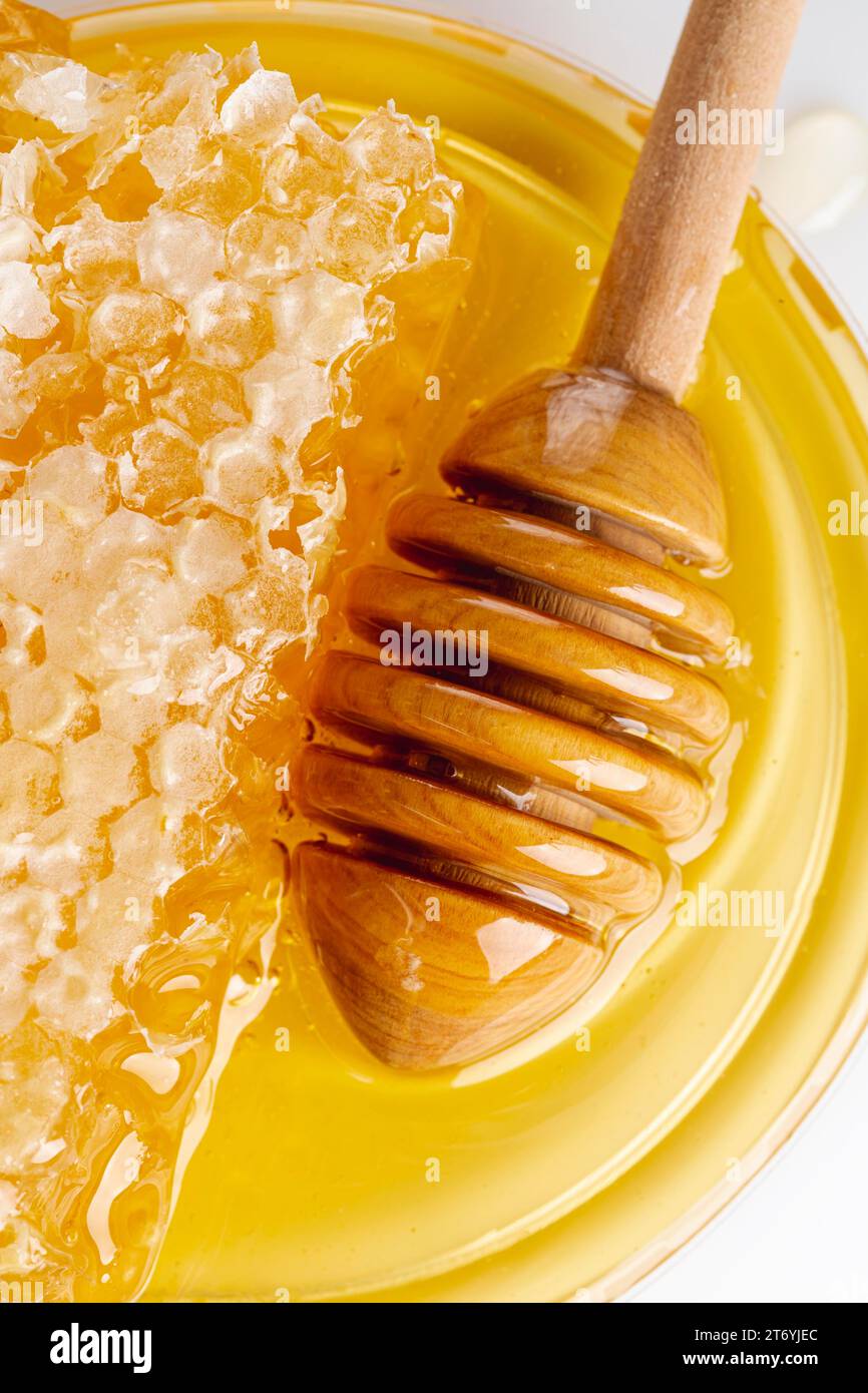 Close up honeycomb with wooden dipper Stock Photo - Alamy