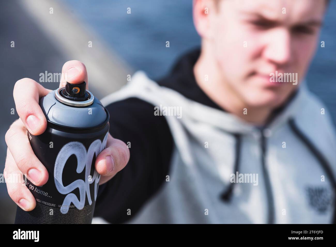 Close up man s hand holding aerosol spray can Stock Photo - Alamy