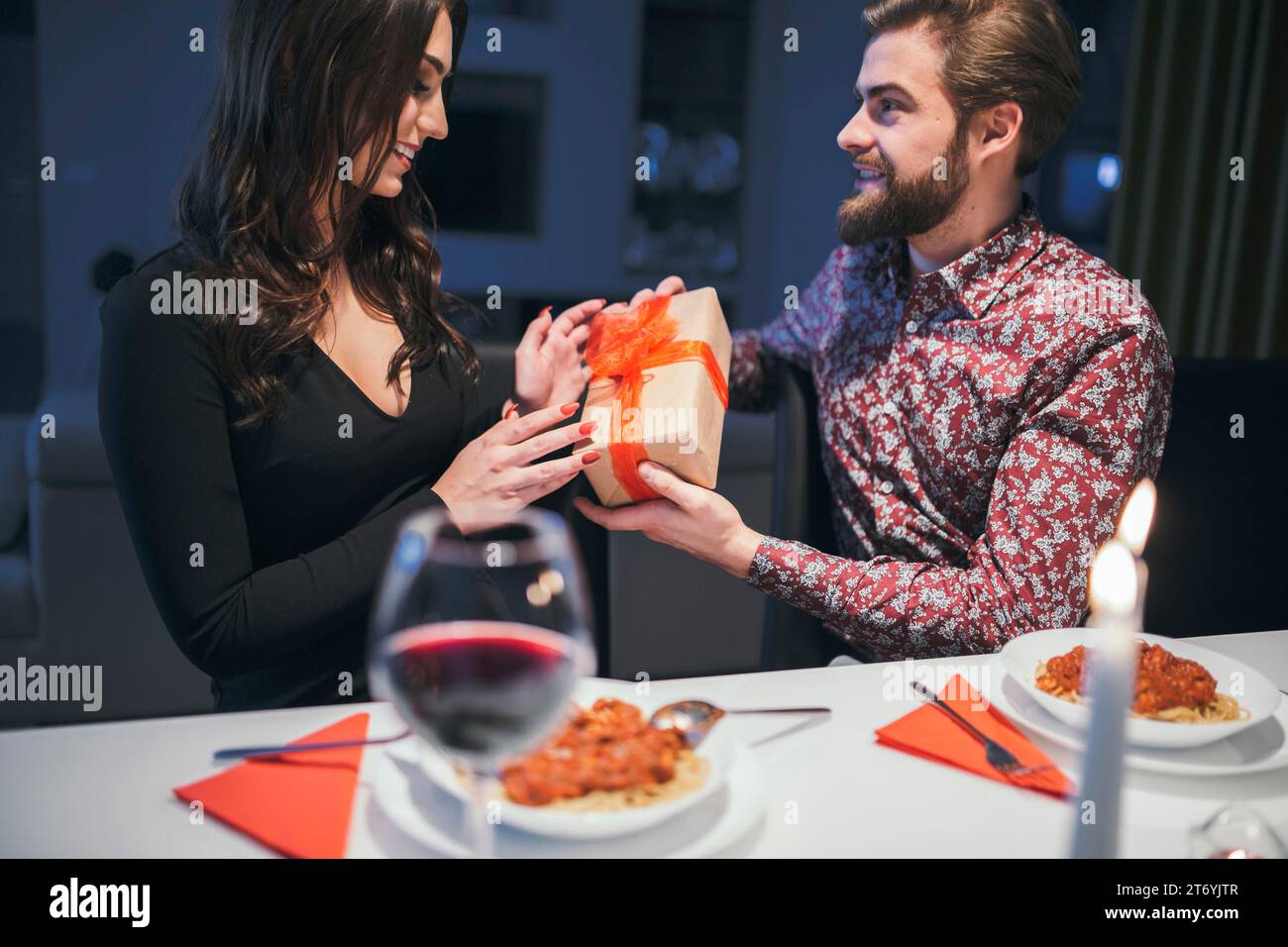 Content man giving present woman Stock Photo - Alamy
