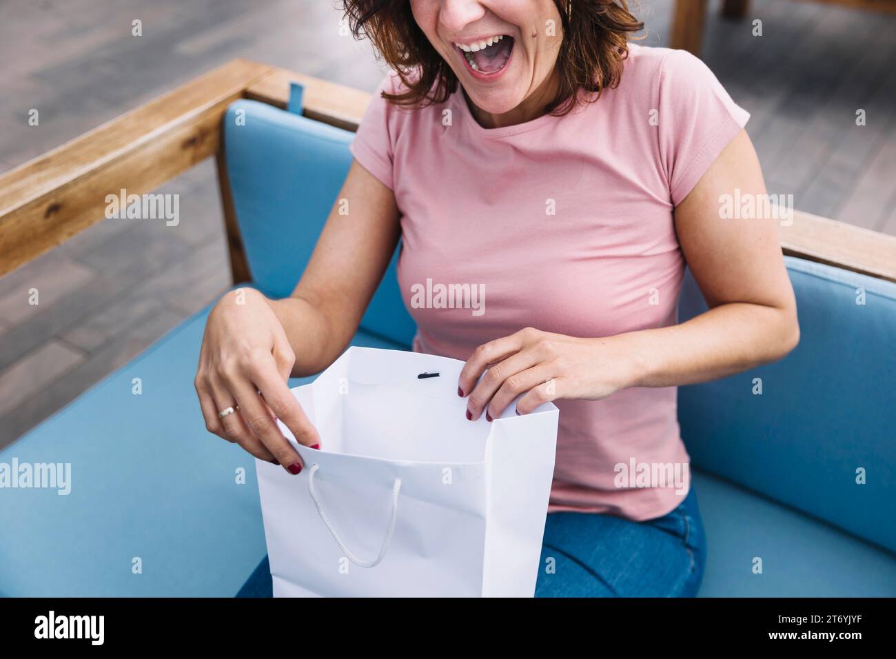 Crop woman opening paper bag Stock Photo - Alamy