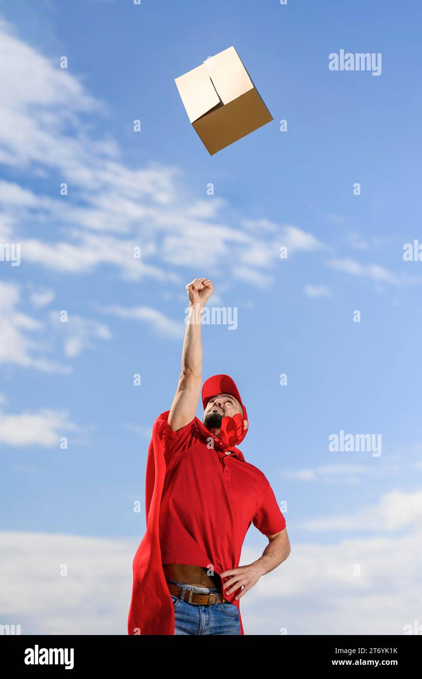 Delivery man throwing parcel air Stock Photo - Alamy