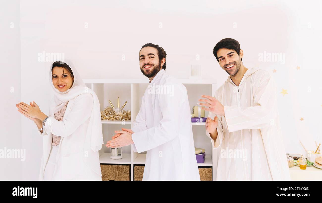 Eid concept with group joyful friends Stock Photo - Alamy