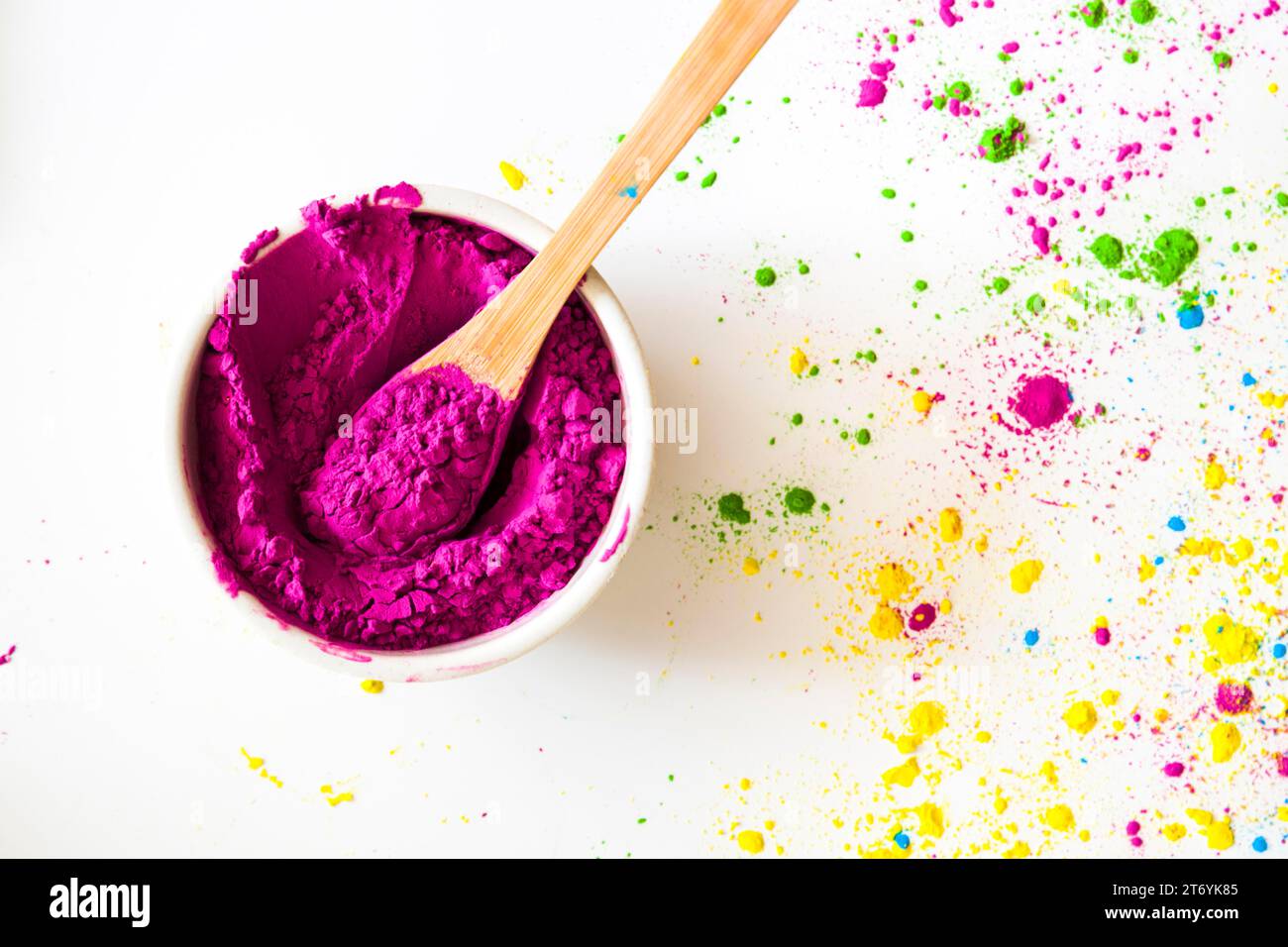 Elevated view pink holi powder bowl with spoon white backdrop Stock ...
