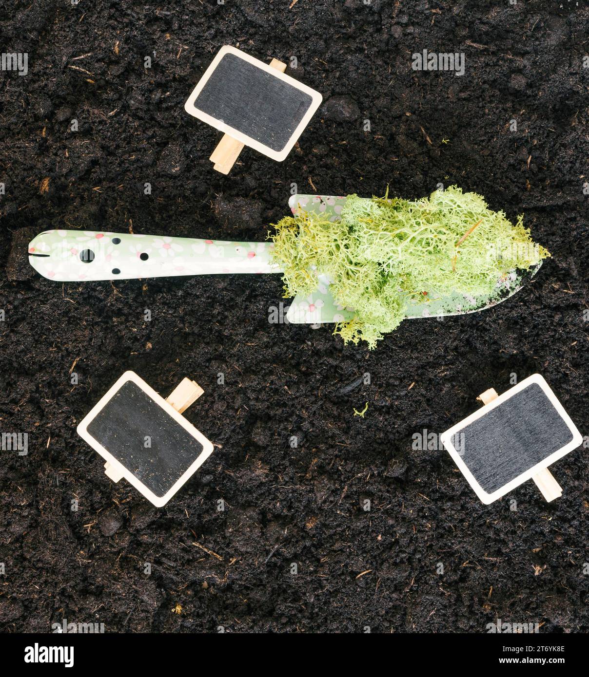 Elevated view blank slate moss shovel black dirt Stock Photo - Alamy