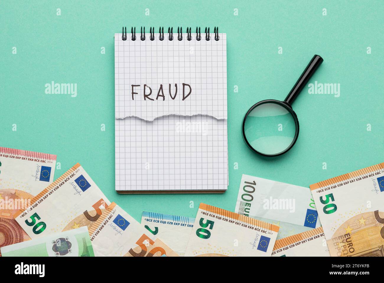 Fraud word written notepad with banknotes Stock Photo - Alamy