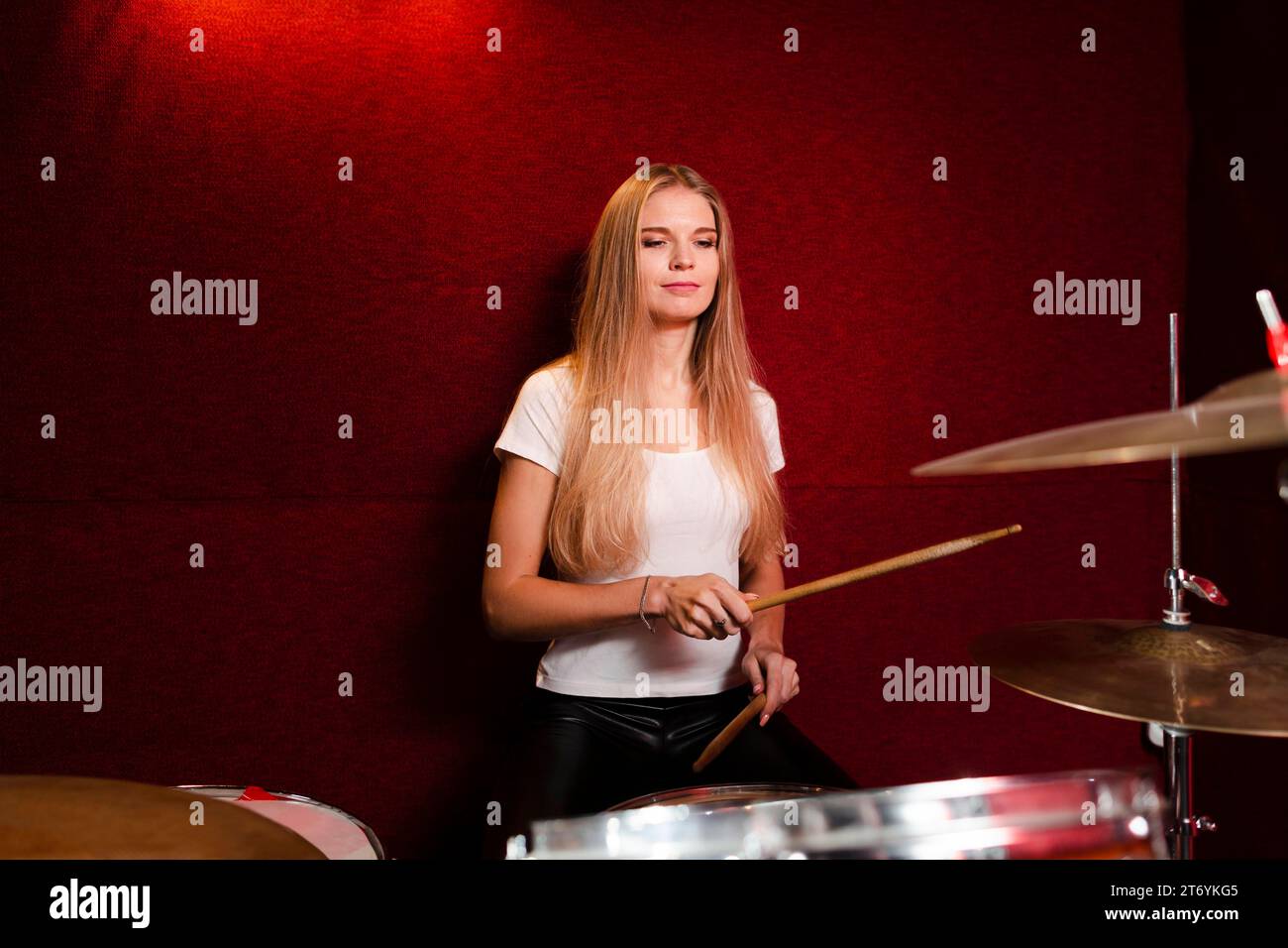 Front view sideways girl playing drums Stock Photo - Alamy