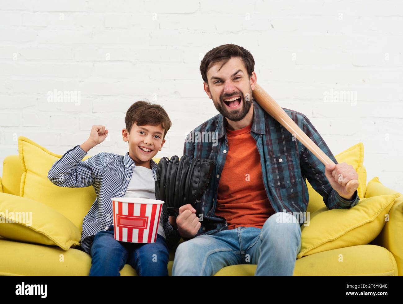 Funny son father holding baseball bat Stock Photo - Alamy