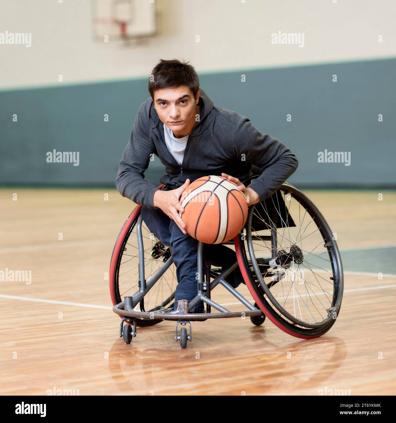 Full shot man holding basketball Stock Photo - Alamy