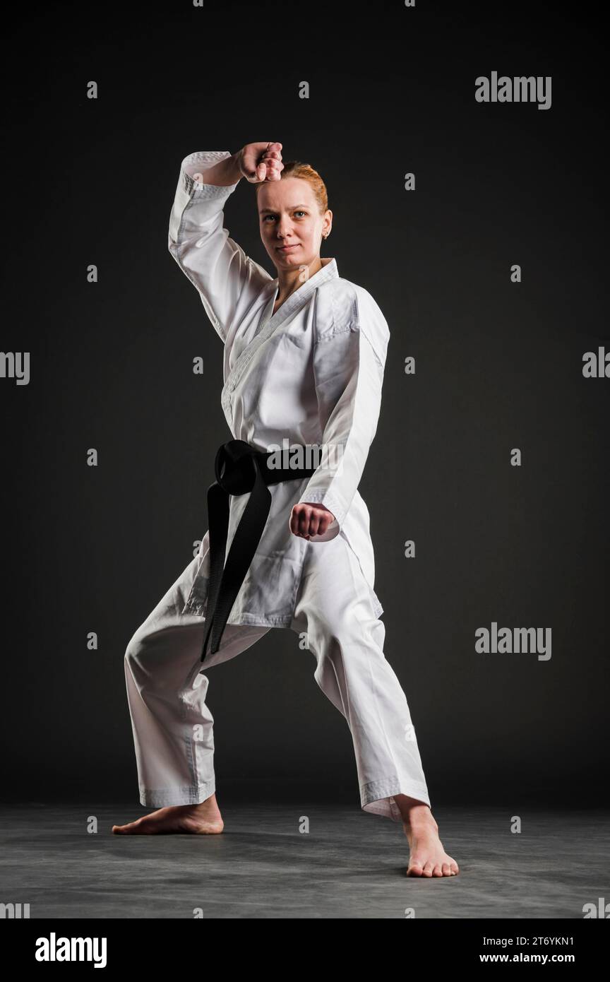 Front view woman doing karate pose Stock Photo - Alamy